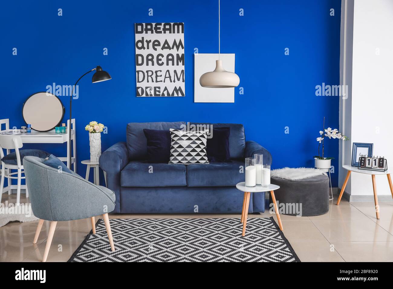 Interior of modern living room with blue wall Stock Photo - Alamy