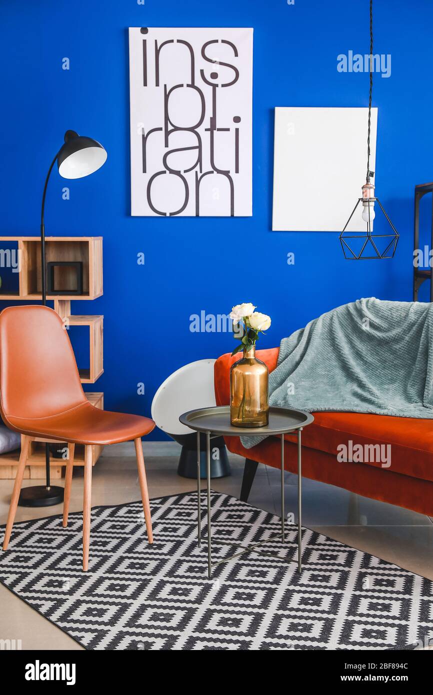 Interior of modern living room with blue wall Stock Photo - Alamy