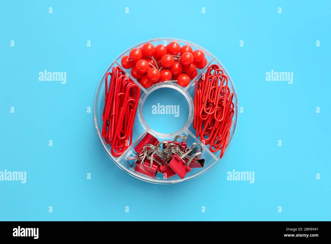 Box with clips and pins on color background Stock Photo - Alamy