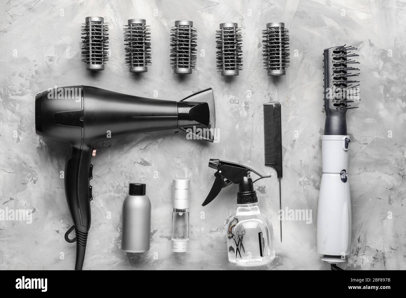 Modern hairdresser tools on grey background Stock Photo - Alamy