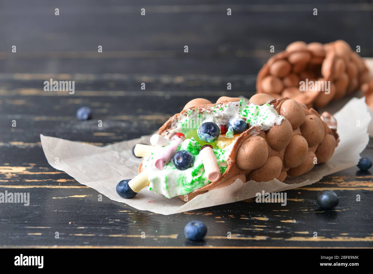Delicious sweet bubble waffle on table Stock Photo - Alamy