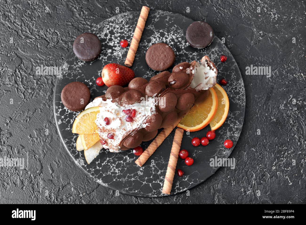 Delicious sweet bubble waffle on dark background Stock Photo - Alamy