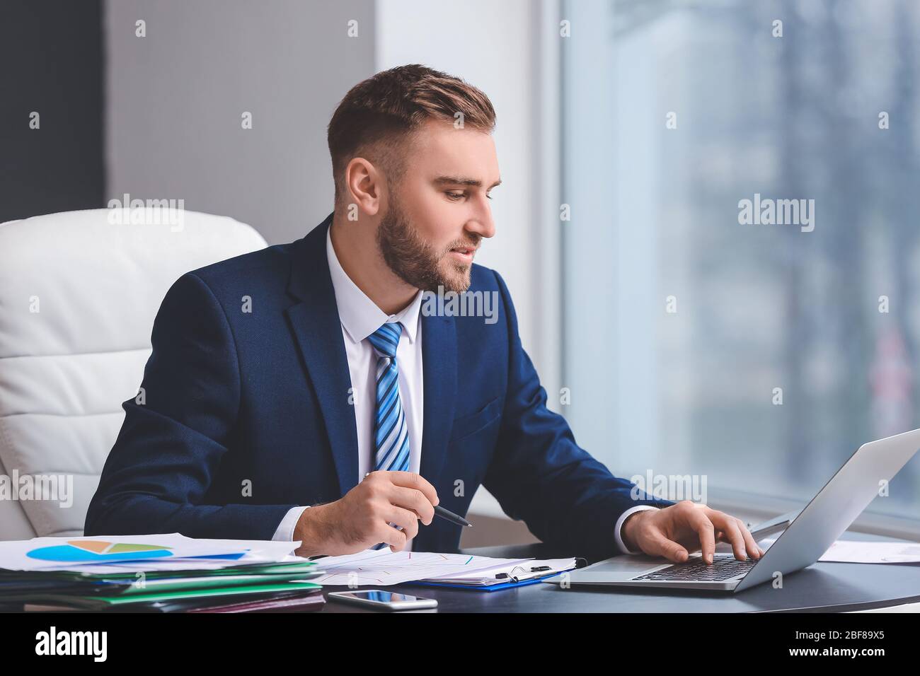 Male accountant working in office Stock Photo - Alamy