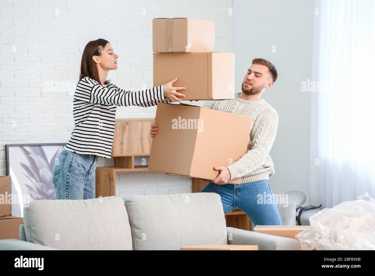 Young couple with belongings in their new flat on moving day Stock ...