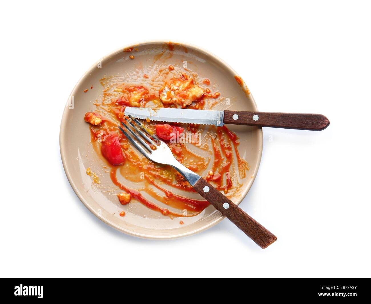Dirty empty plate with cutlery on white background Stock Photo - Alamy
