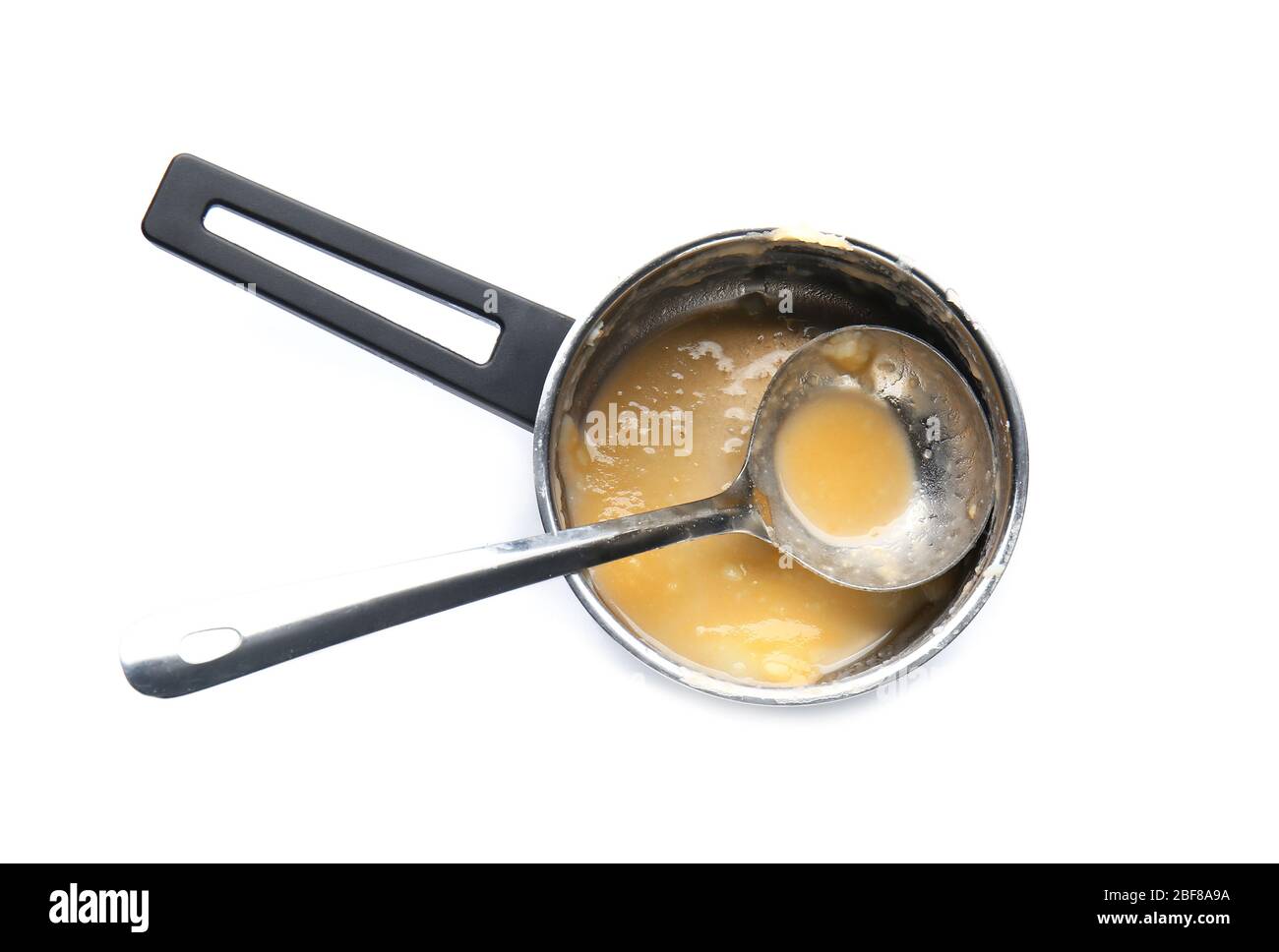 Dirty empty saucepan with ladle on white background Stock Photo - Alamy