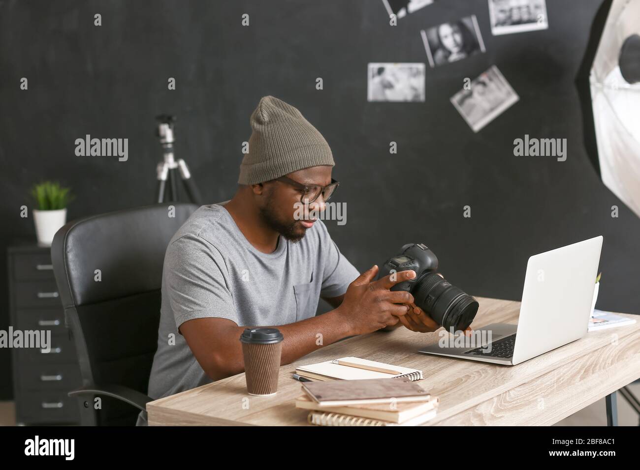 African-American photographer at table in studio Stock Photo - Alamy