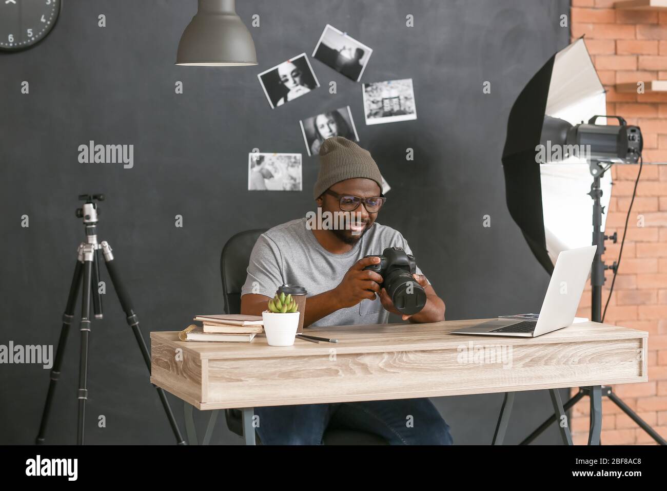 African-American photographer at table in studio Stock Photo - Alamy
