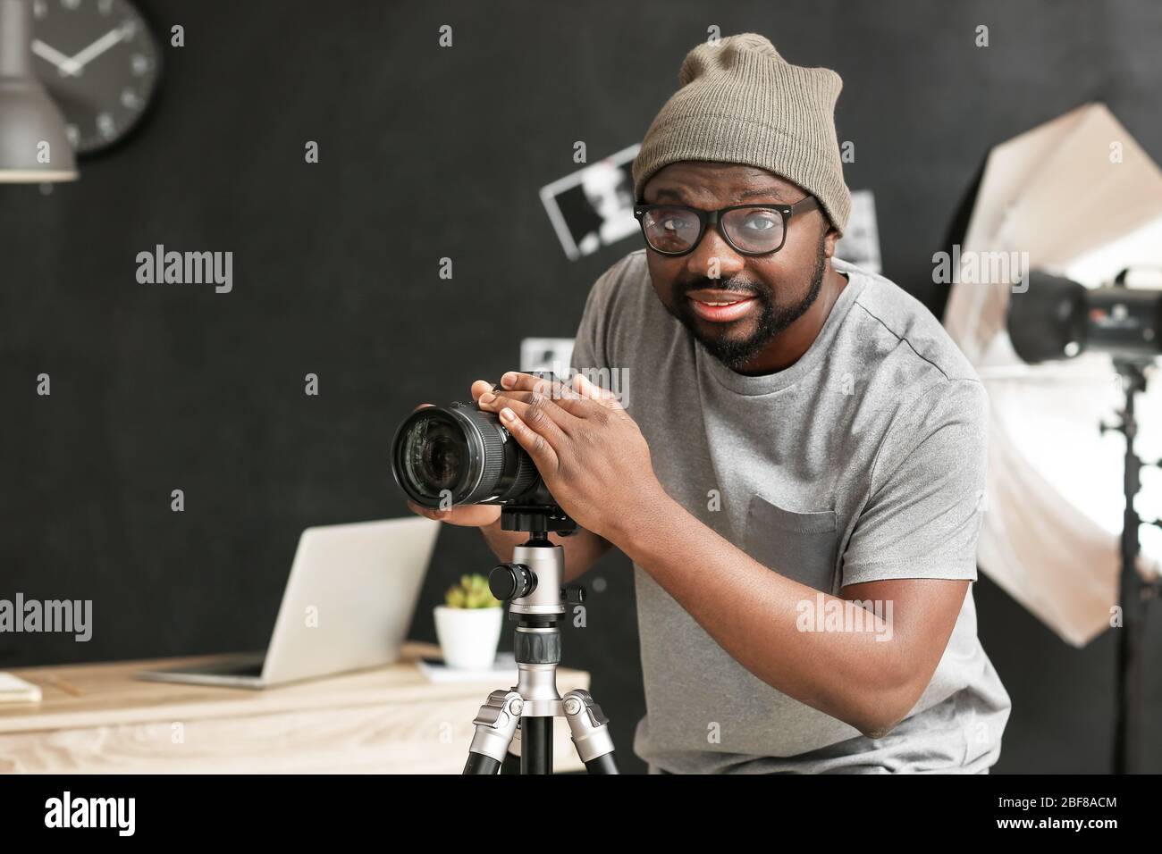 African-American photographer with camera in studio Stock Photo - Alamy