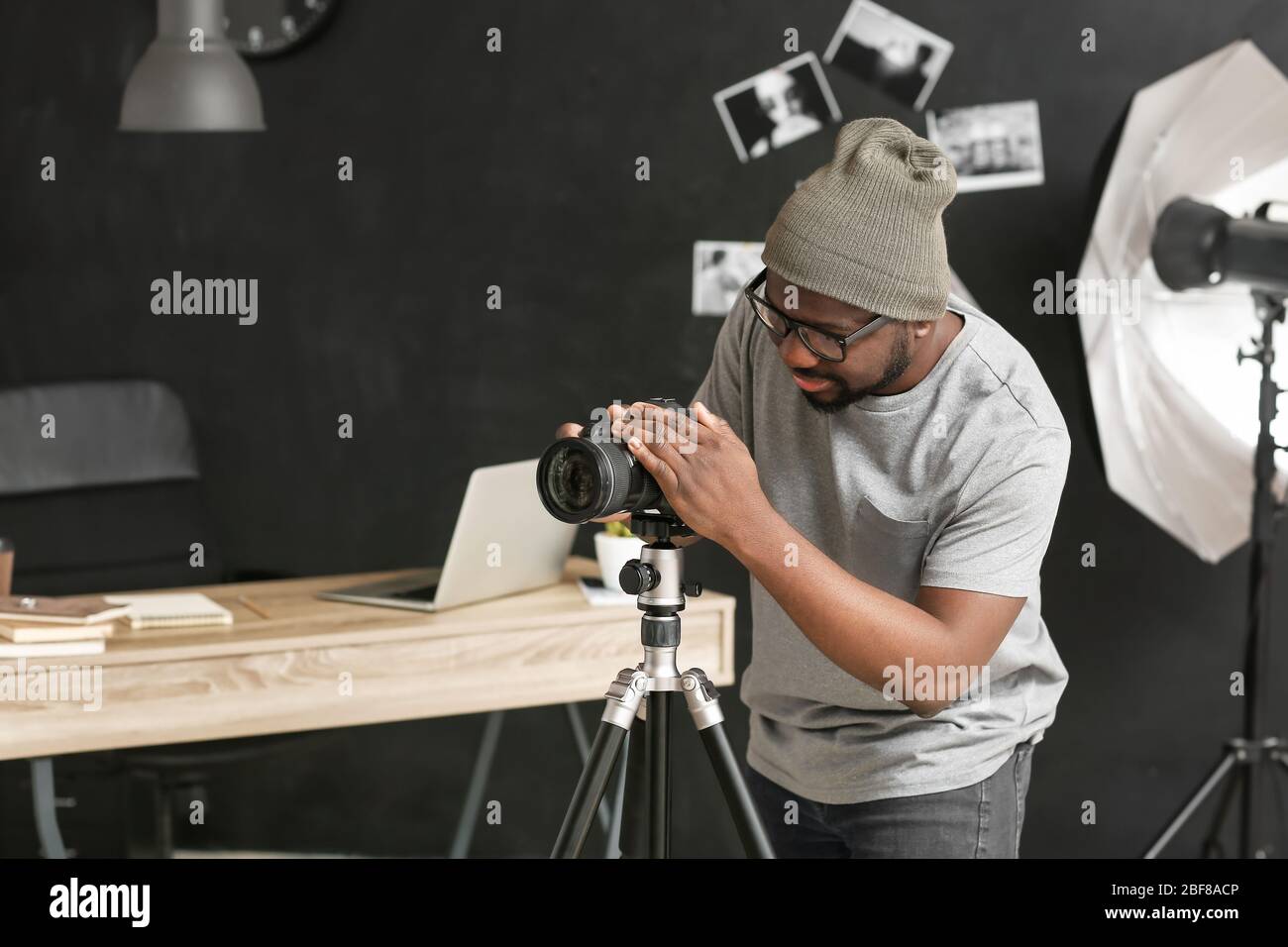 African-American photographer with camera in studio Stock Photo - Alamy