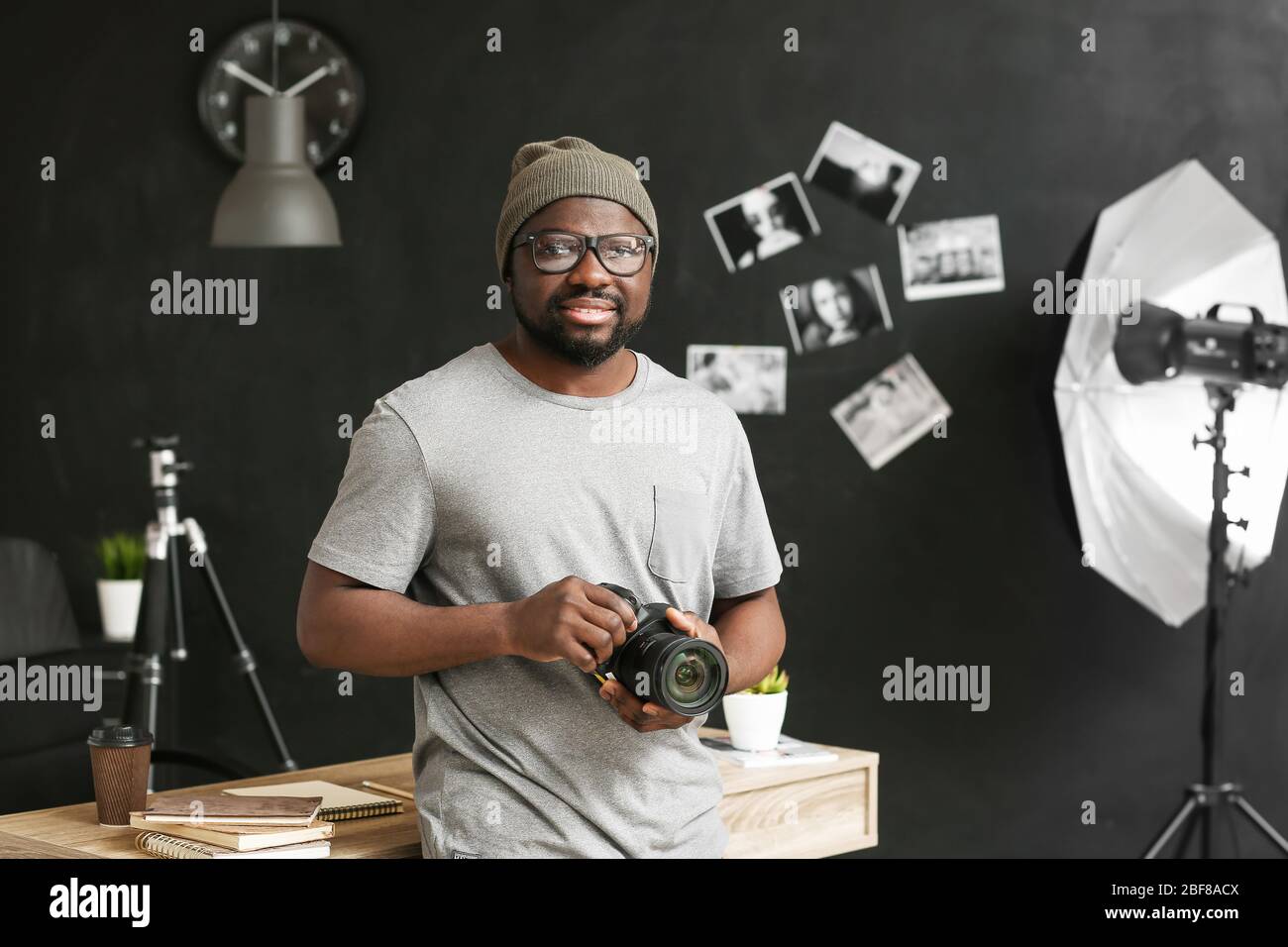 African-American photographer with camera in studio Stock Photo - Alamy