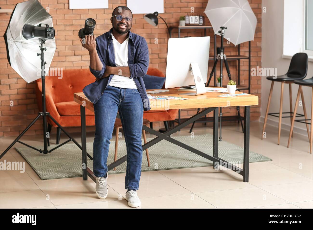 African-American photographer in modern studio Stock Photo - Alamy