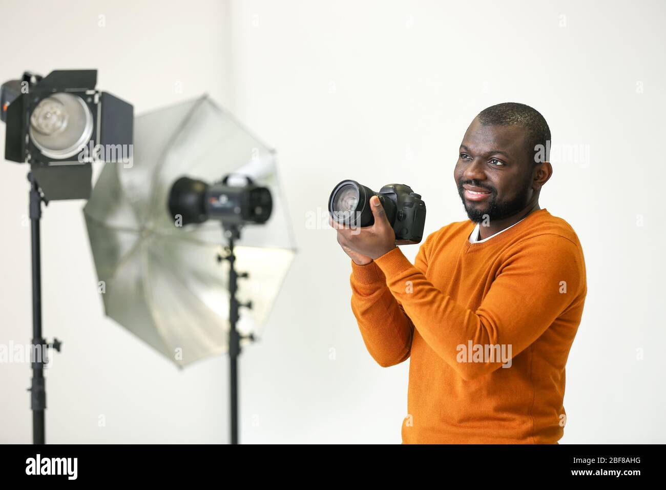 African-American photographer in modern studio Stock Photo - Alamy