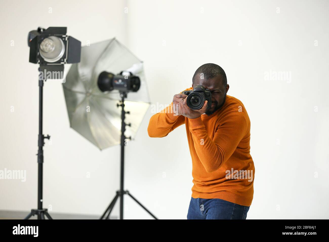 African-American photographer in modern studio Stock Photo - Alamy