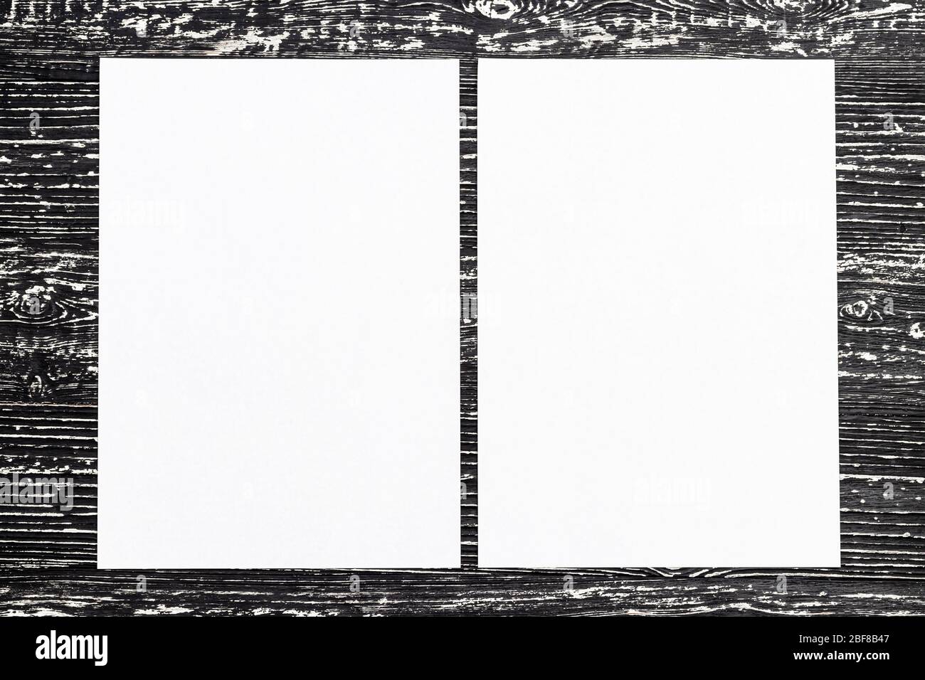 White paper on a black wooden table. Abstract background for design ...