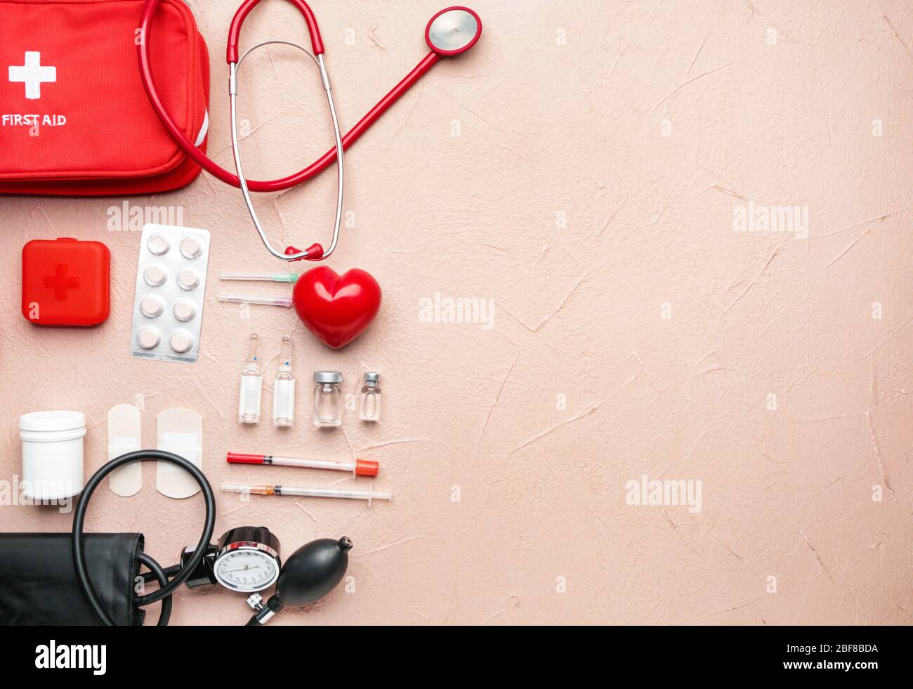 First aid kit on color background Stock Photo - Alamy