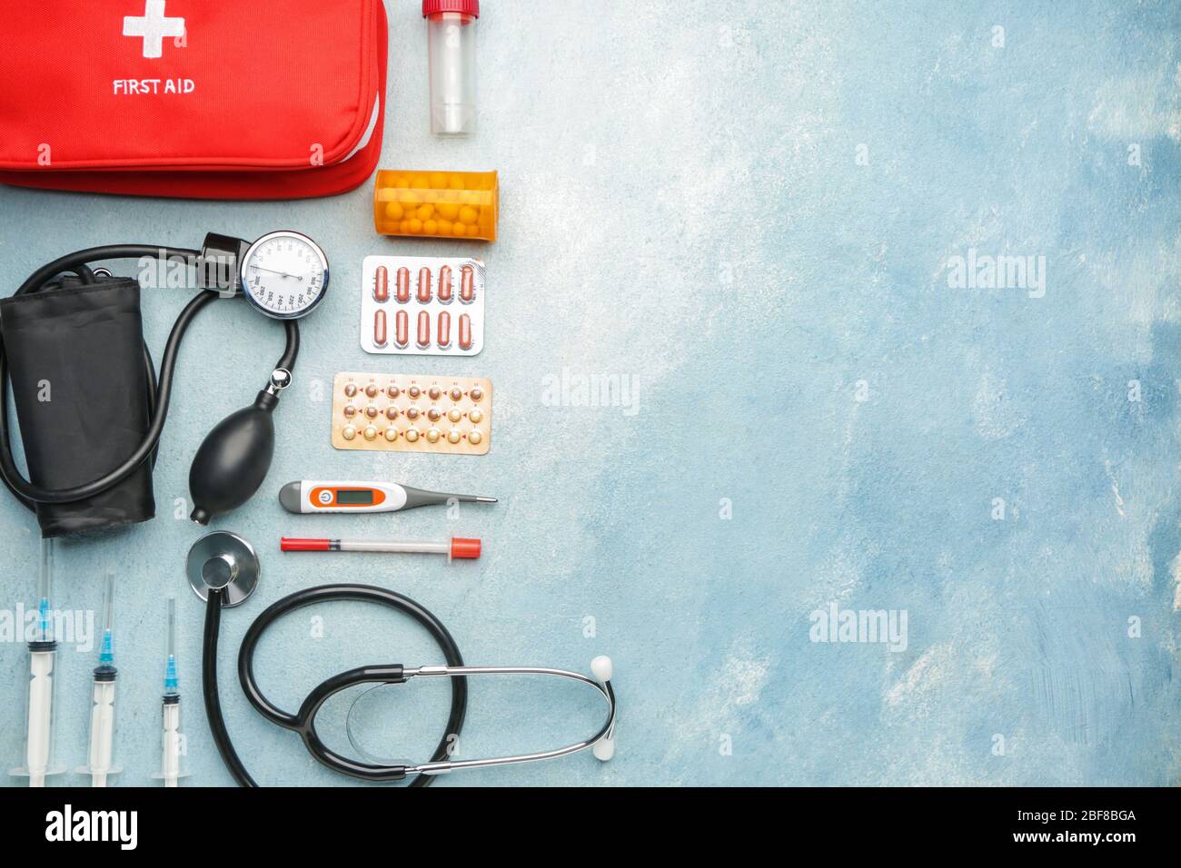 First aid kit on color background Stock Photo - Alamy