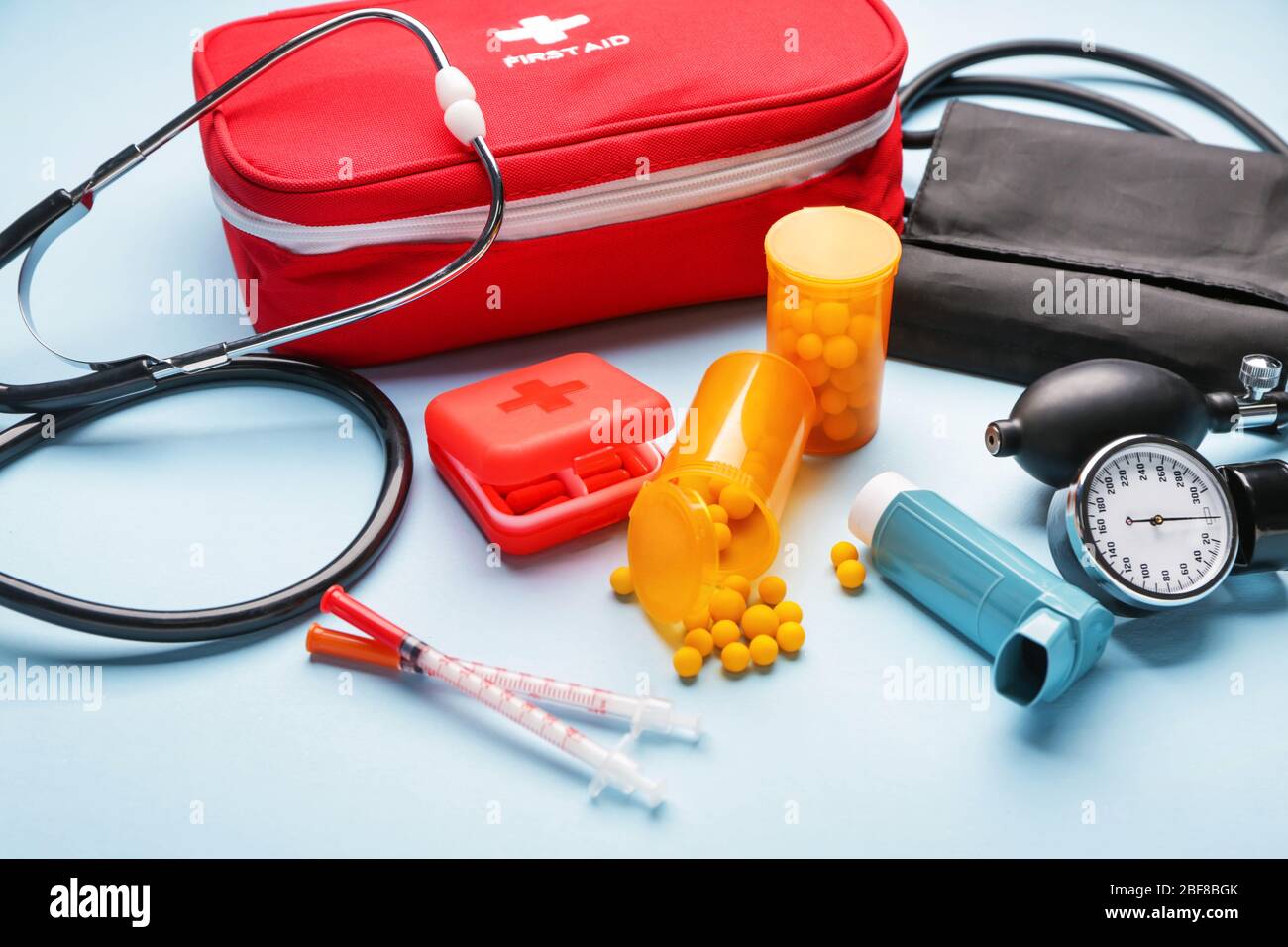 First aid kit on color background Stock Photo - Alamy