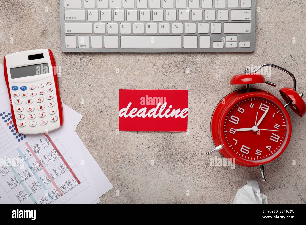 Word DEADLINE with alarm clock, calculator, documents and computer ...