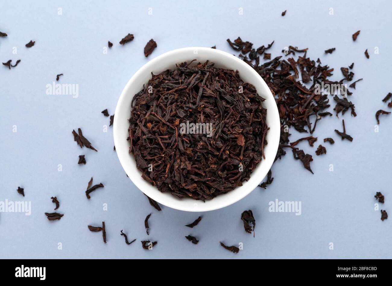 Dry black tea leaves isolated on white background, top view Stock Photo ...