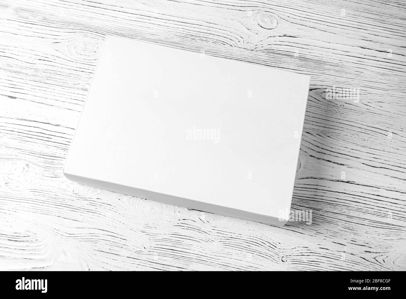 White cardboard box on a wooden table. Abstract background for design ...