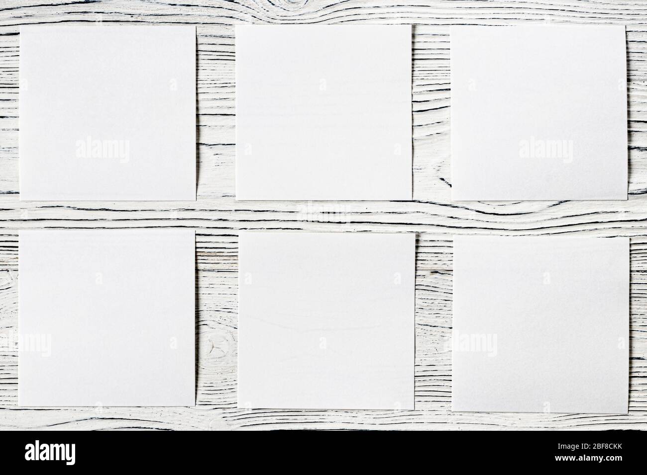 White paper sheets on a wooden table. Abstract background for design ...