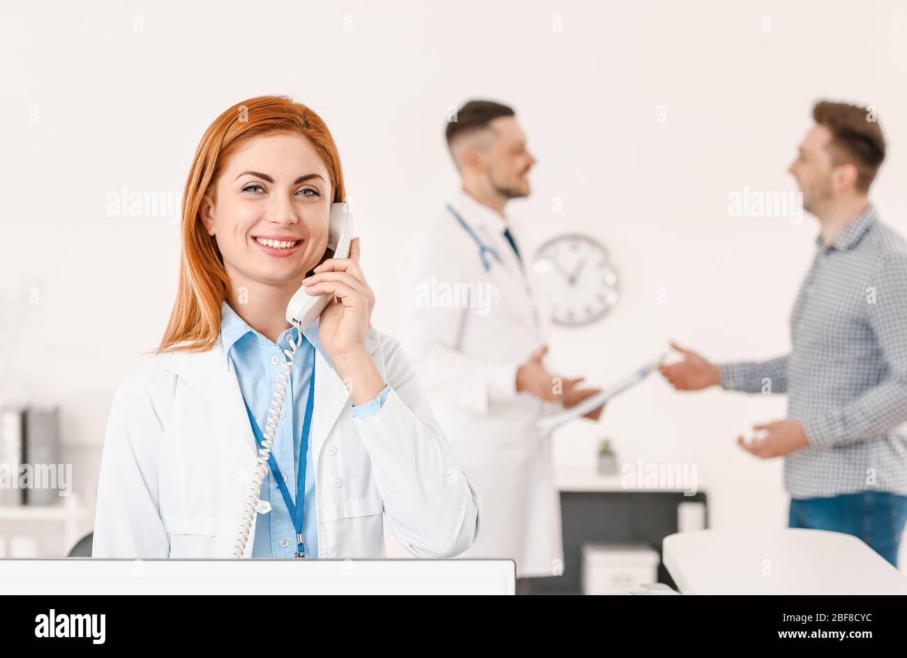 Female medical assistant working in clinic Stock Photo - Alamy