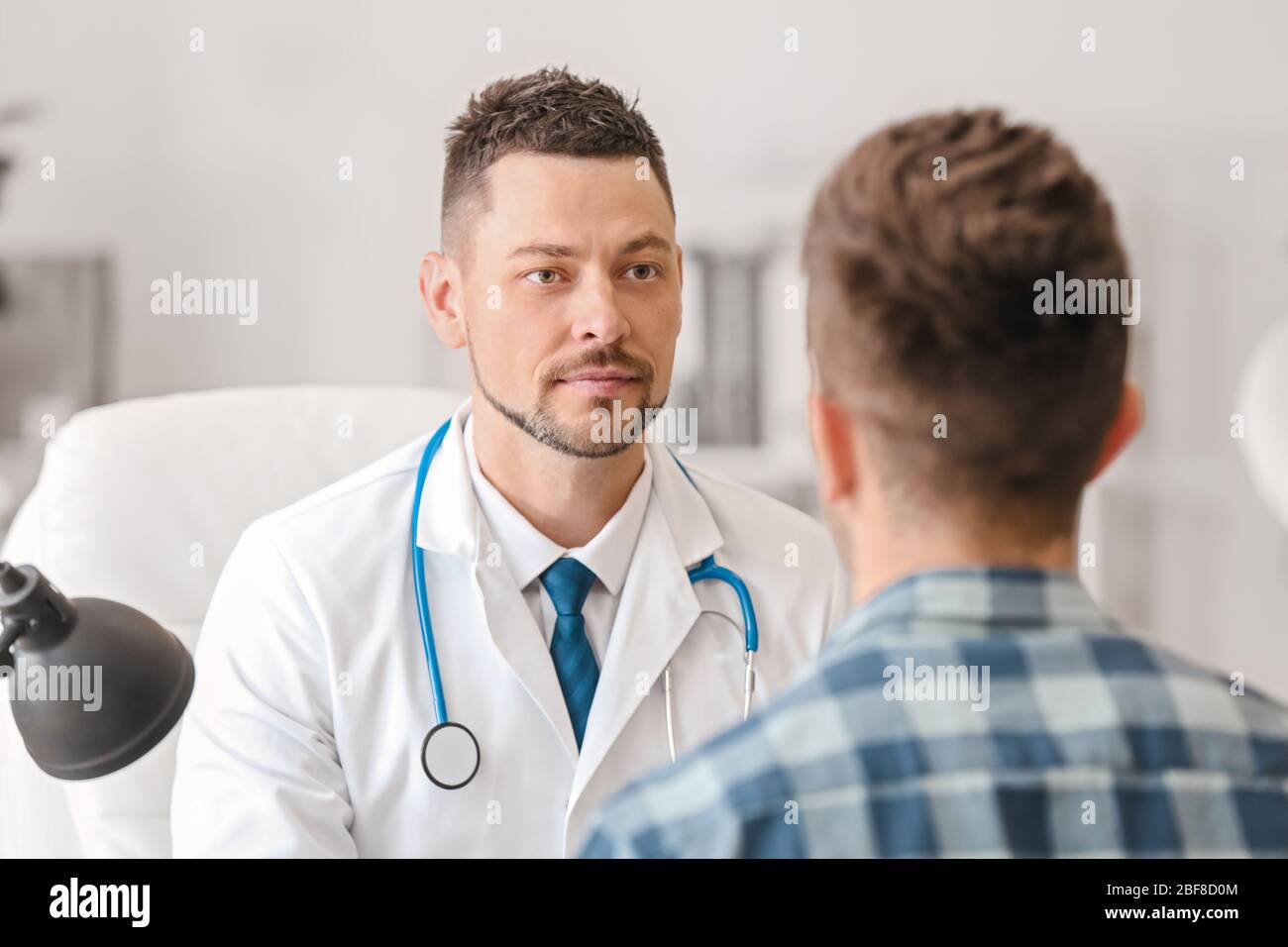 Male patient visiting doctor hi-res stock photography and images - Alamy