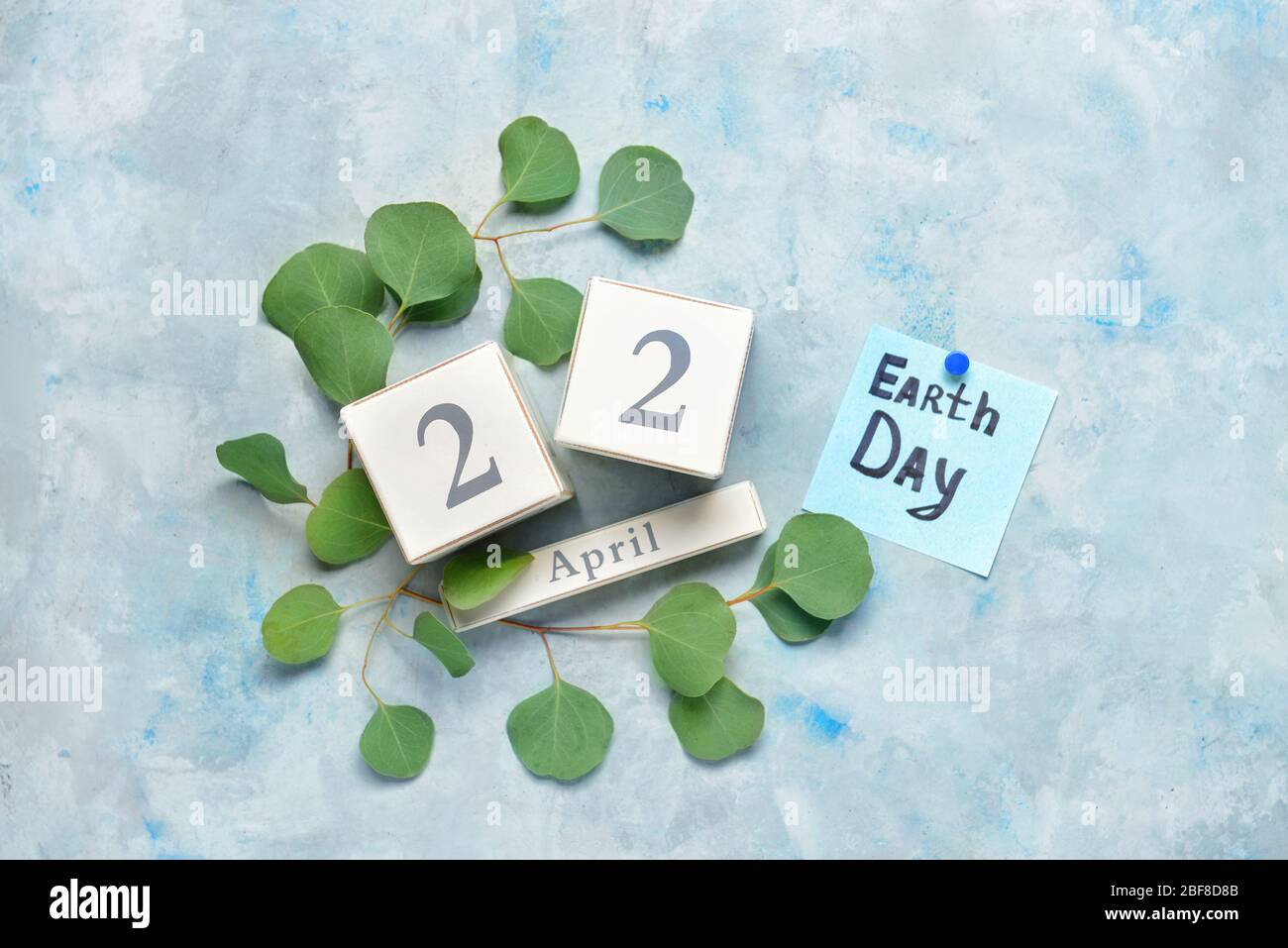 Calendar with date of Earth Day and plants on color background Stock ...