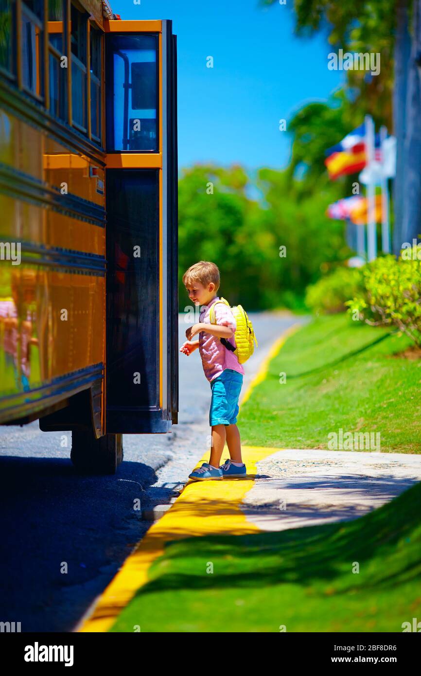 Young Boy Kid Getting On The School Bus Ready To Go To School Stock young-boy-kid-getting-on-the-school-bus-ready-to-go-to-school-stock