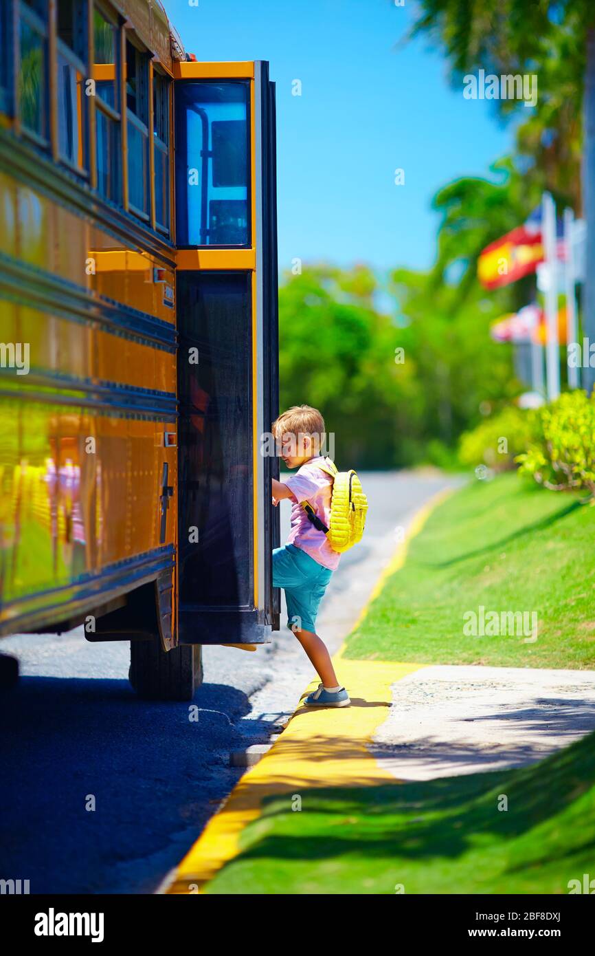 young boy, kid getting on the school bus, ready to go to school Stock ...
