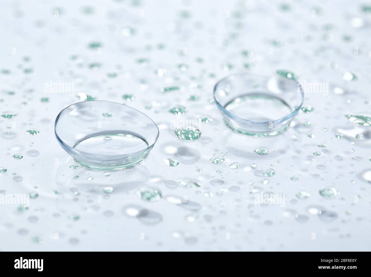 Contact lenses on wet background Stock Photo - Alamy