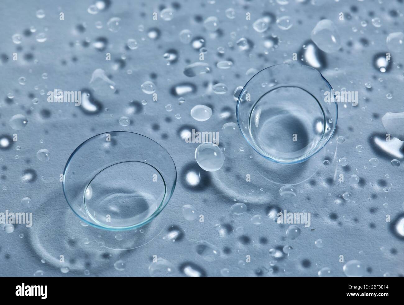 Contact lenses on wet background Stock Photo - Alamy
