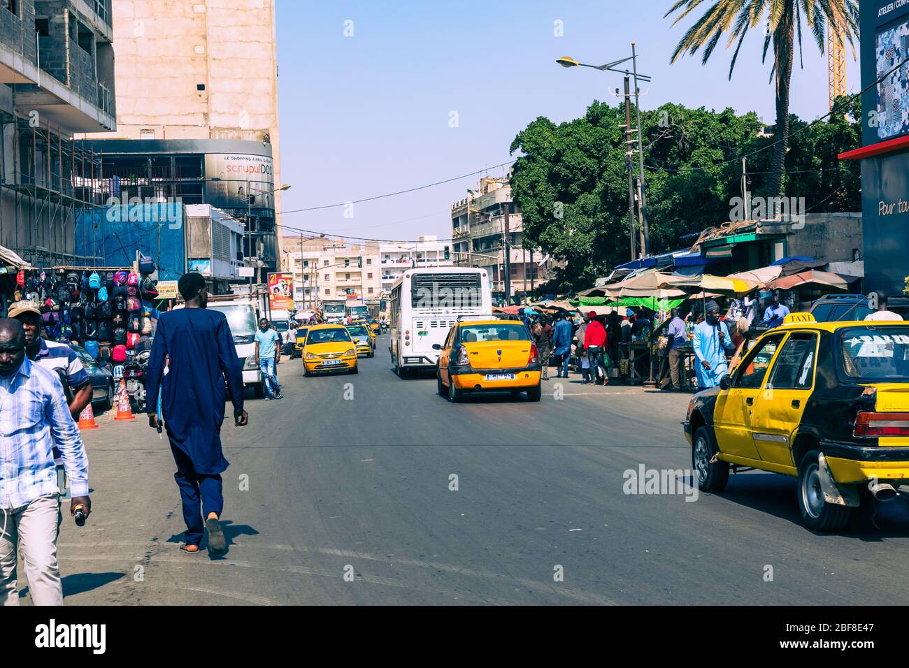 DAKAR, SENEGAL - NOVEMBER 11, 2019: People working and traffic at ...