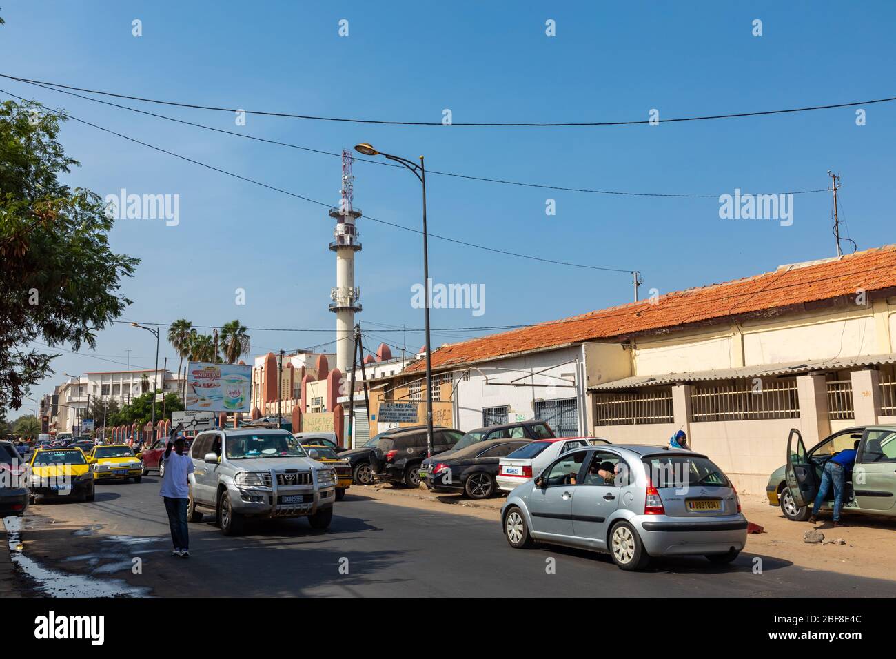 DAKAR, SENEGAL - NOVEMBER 11, 2019: People working and traffic at ...