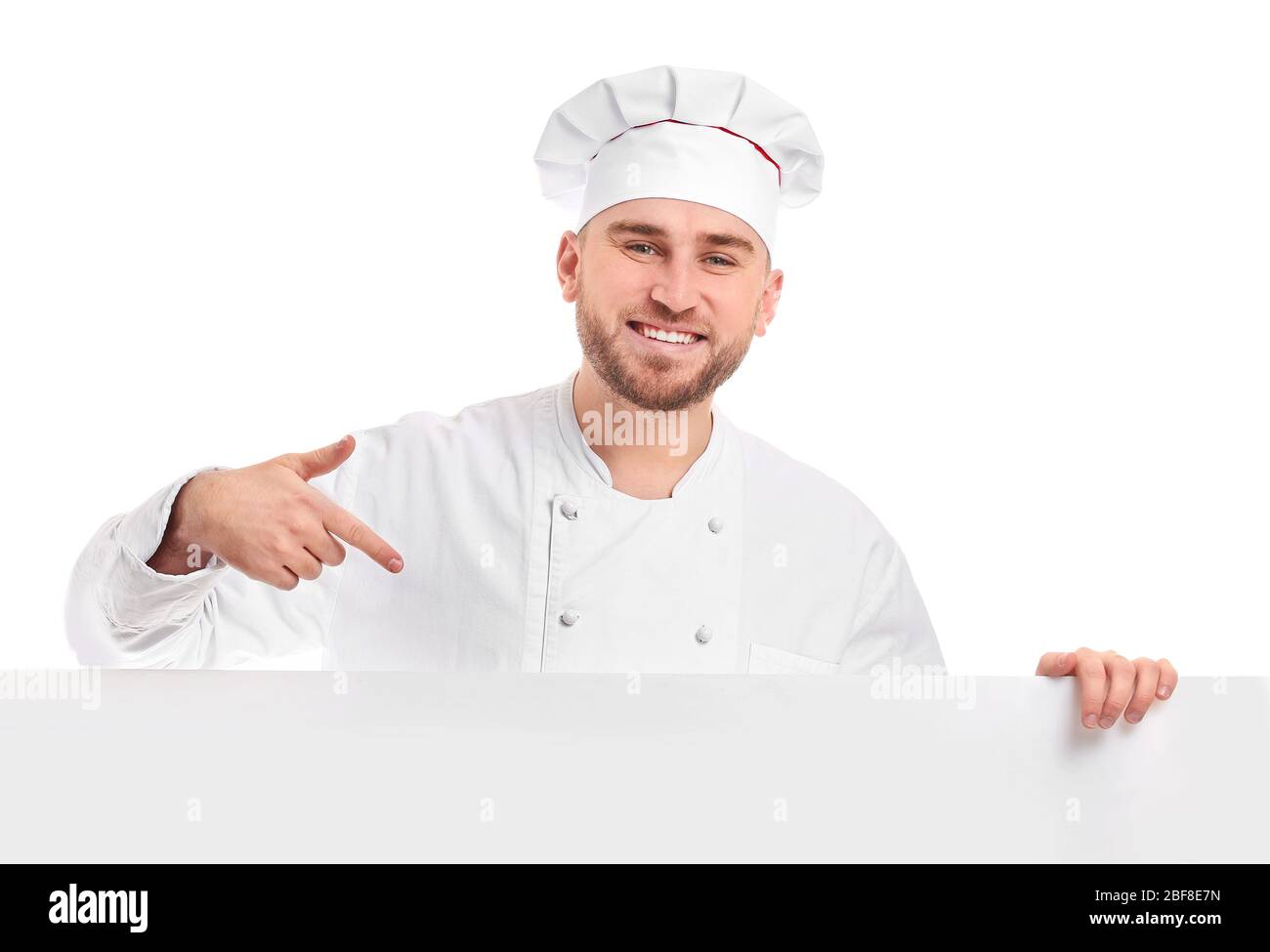 Handsome male chef with blank poster on white background Stock Photo ...
