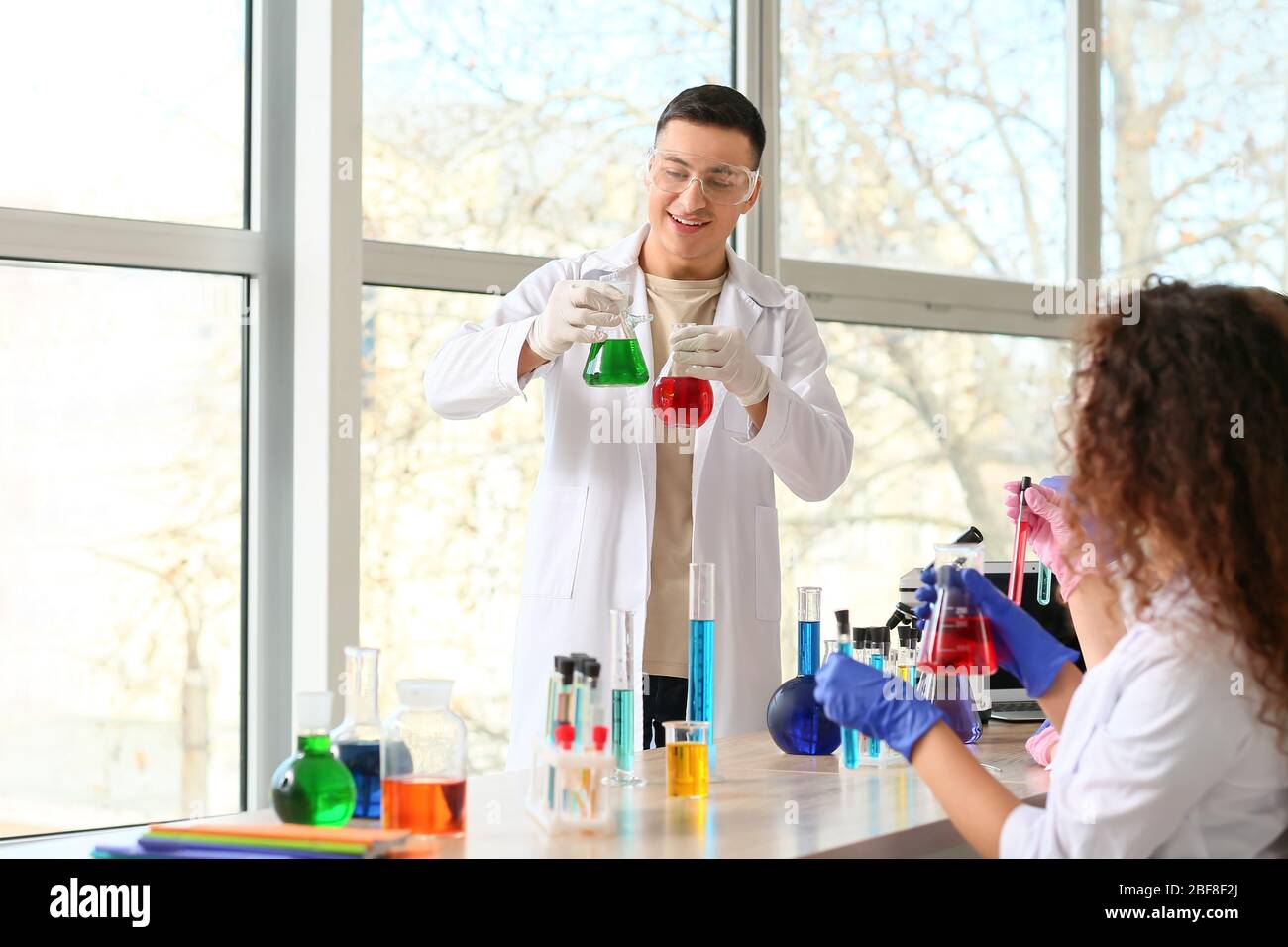 Teacher conducting chemistry lesson in classroom Stock Photo - Alamy