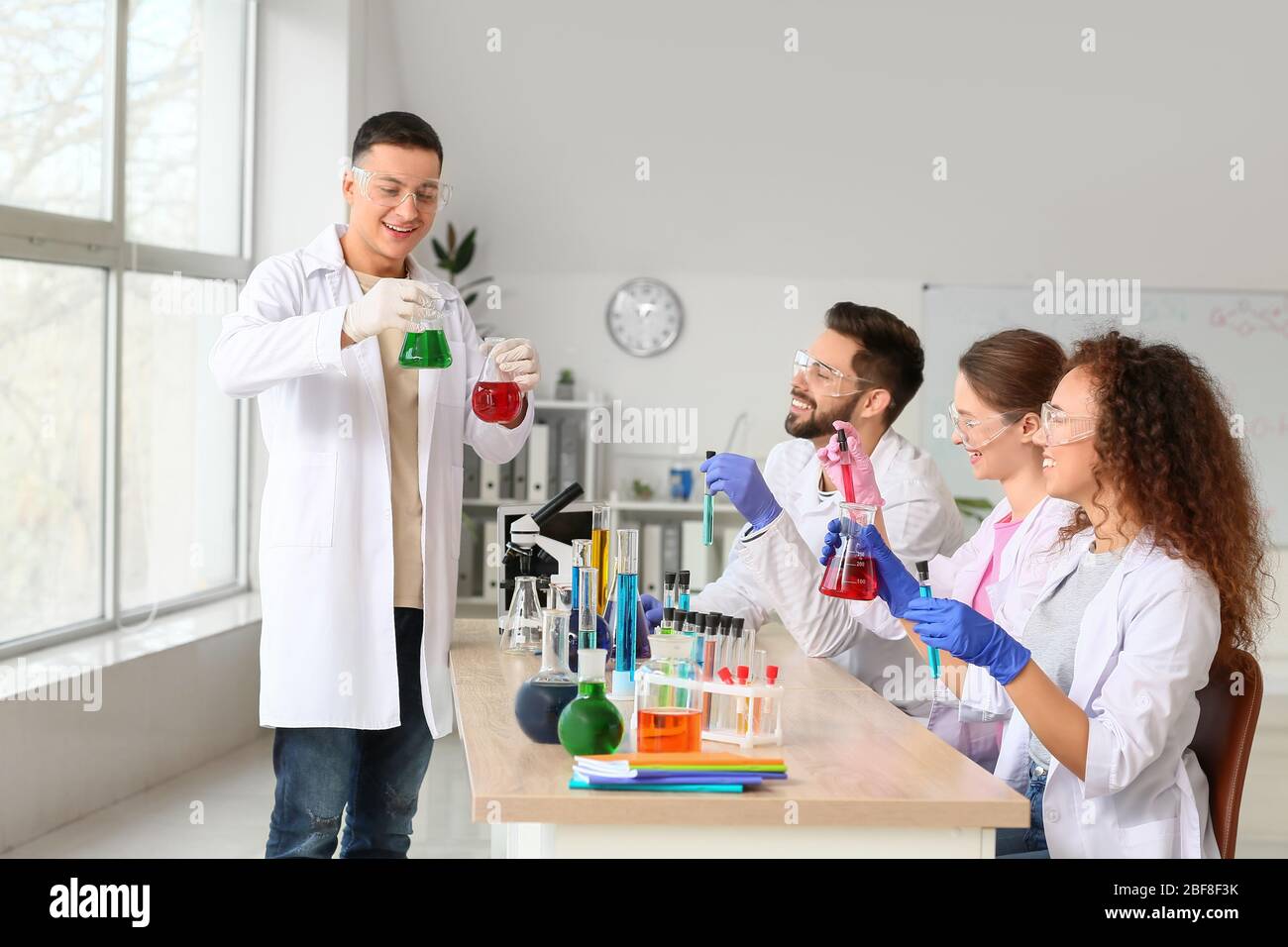 Teacher conducting chemistry lesson in classroom Stock Photo - Alamy