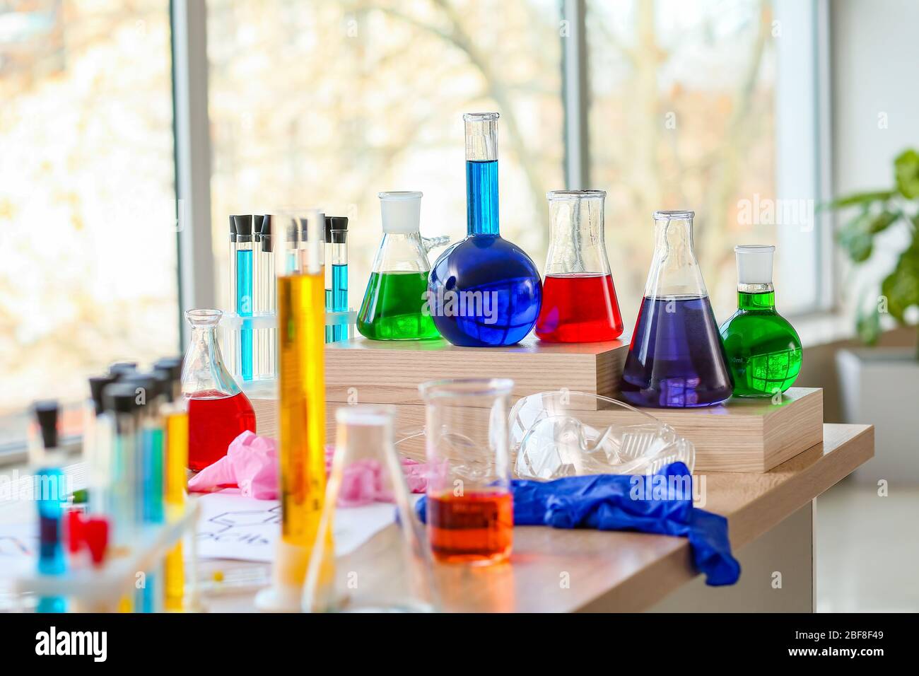 Laboratory glassware with samples on table in classroom Stock Photo - Alamy