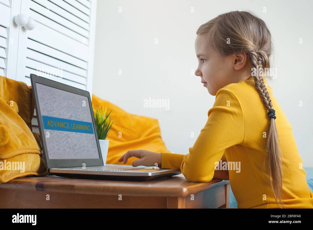 Smart child girl learning at home. Little girl using laptop. Distance ...