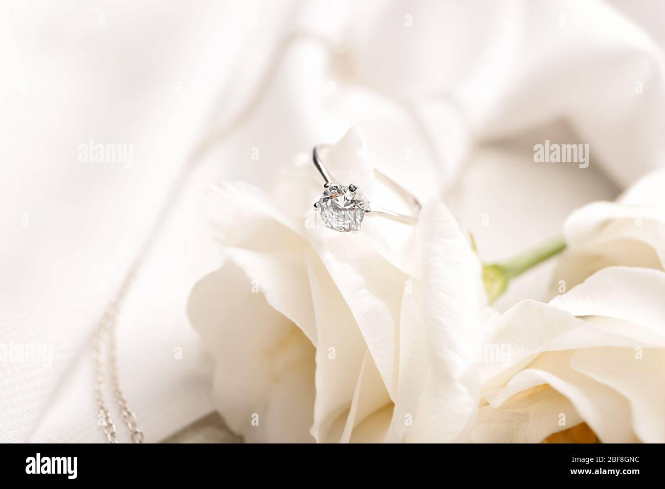 Flowers with beautiful engagement ring, closeup Stock Photo - Alamy