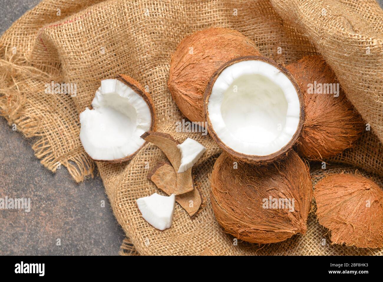 Ripe coconuts on grey background Stock Photo - Alamy