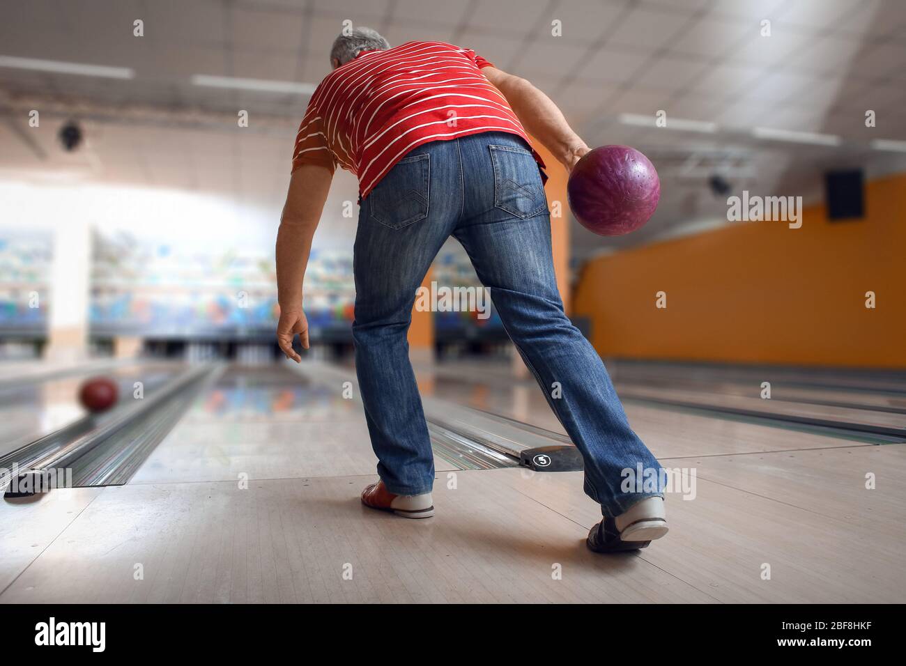Senior man playing bowling in club Stock Photo - Alamy