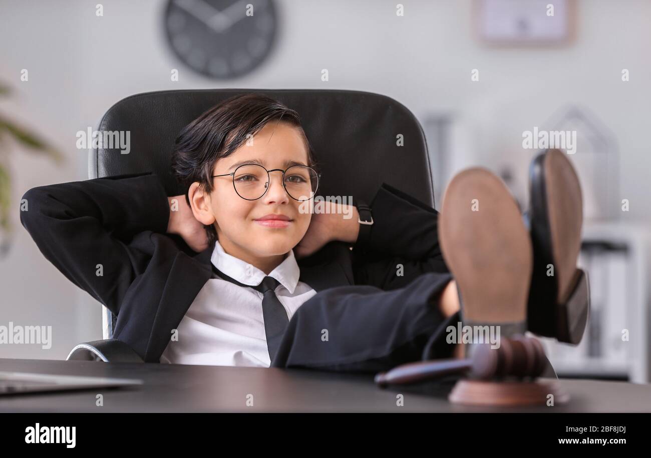 Little lawyer resting at workplace in office Stock Photo - Alamy