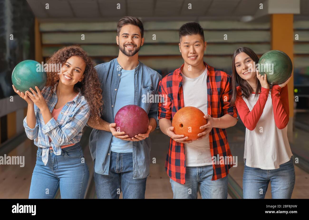 Friends with balls in bowling club Stock Photo - Alamy