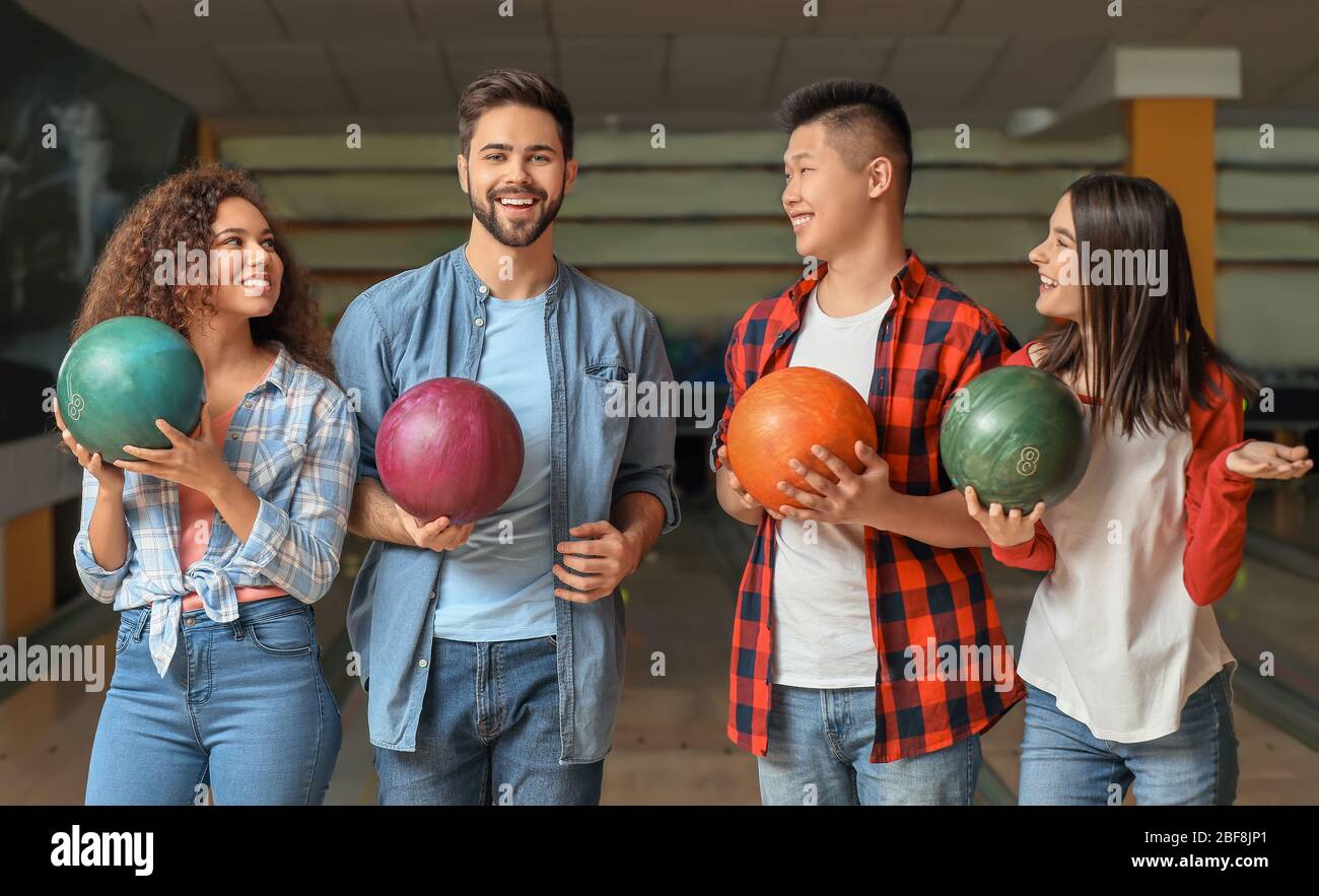 Friends with balls in bowling club Stock Photo - Alamy
