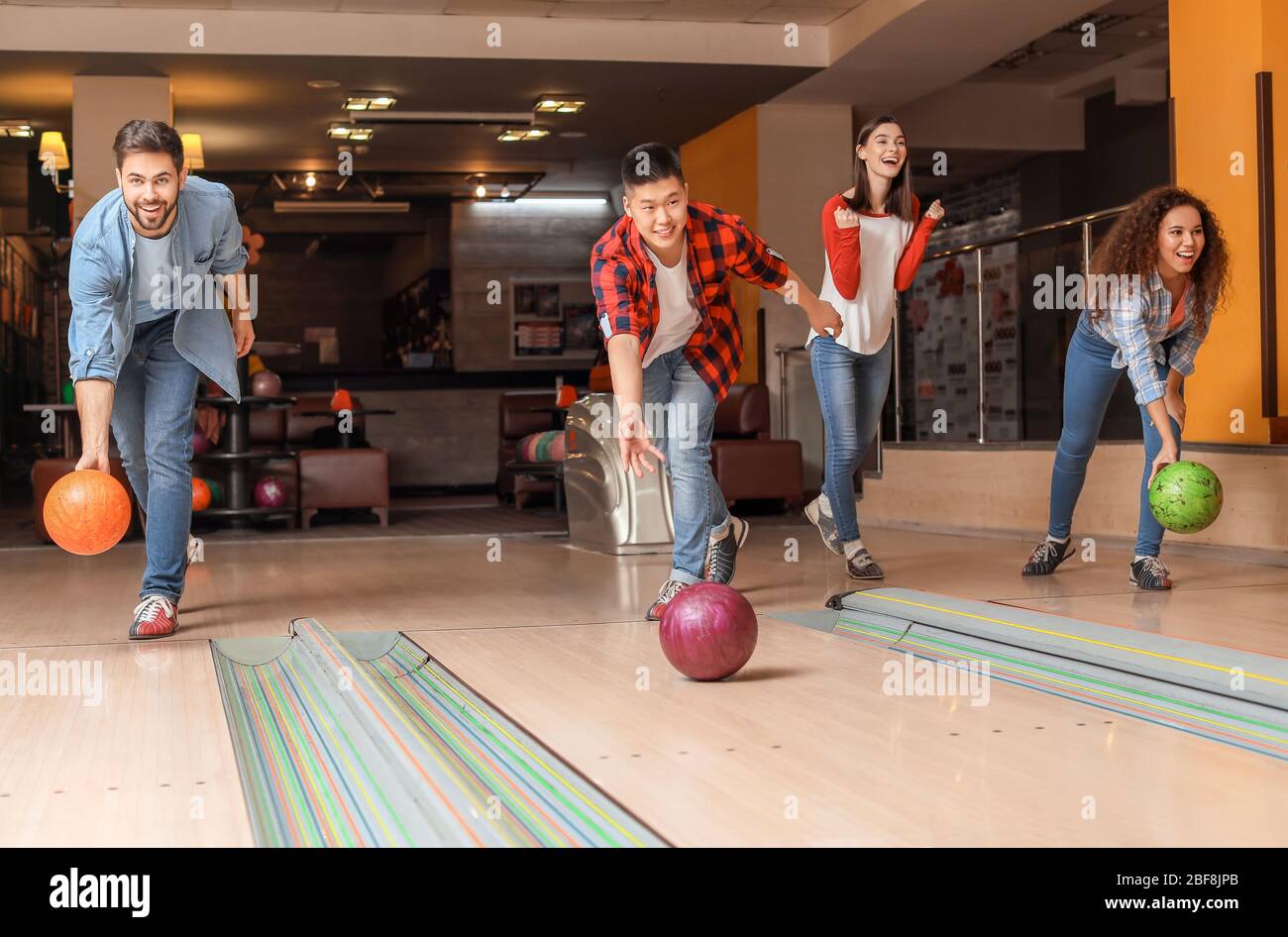 Friends playing bowling in club Stock Photo - Alamy