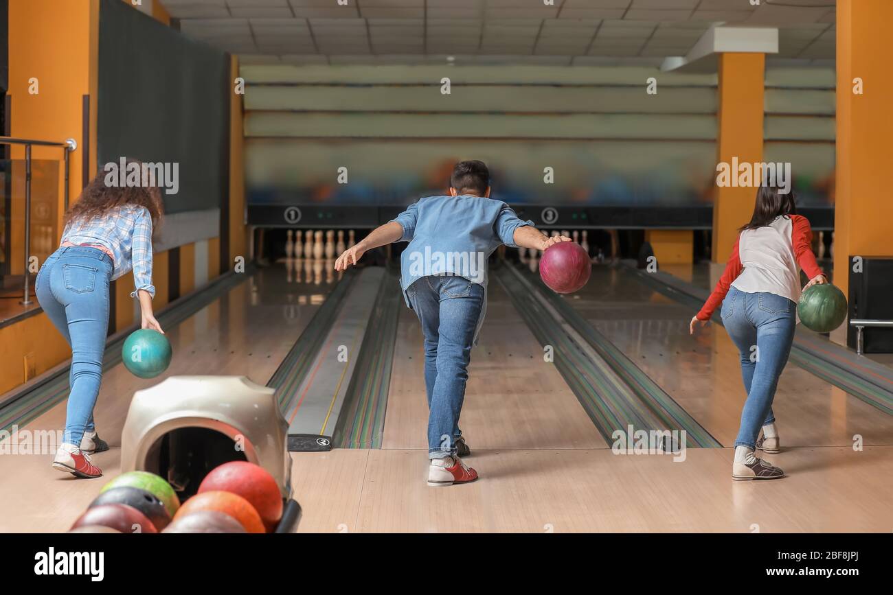 Friends playing bowling in club Stock Photo - Alamy
