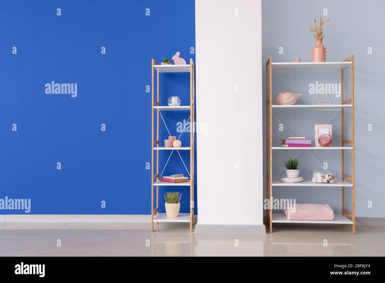 Modern shelf units near color wall Stock Photo - Alamy