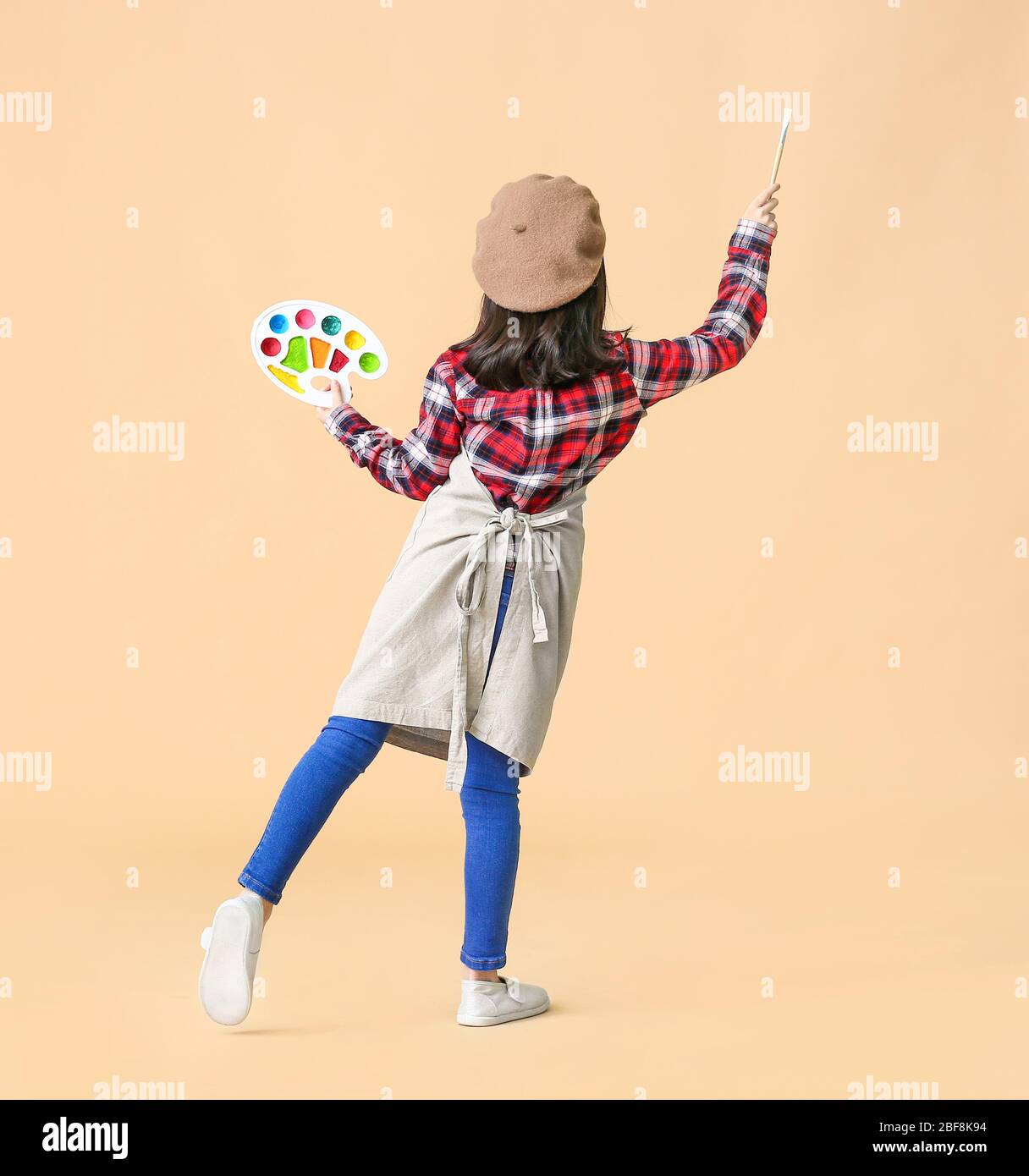 Cute little artist on color background Stock Photo - Alamy